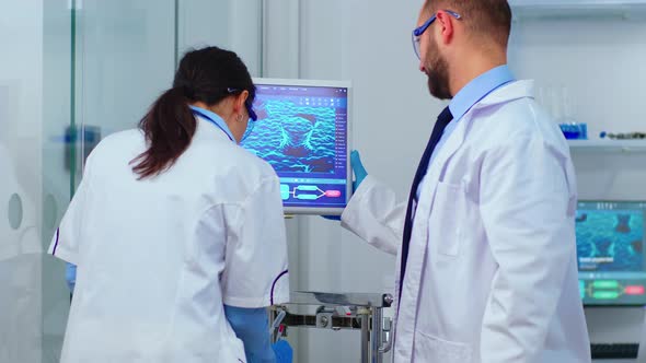 Scientist Team Arguing in Front of Computer Looking at Virus ...