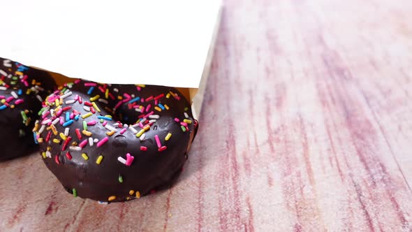 Chocolate Donuts in a Packet on Table, Stock Footage | VideoHive