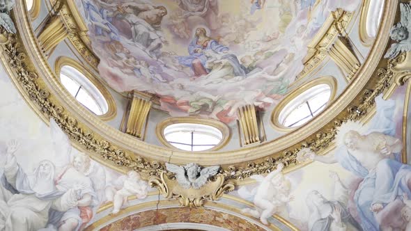 Panning past beautiful ceiling artwork inside Roman church, Stock Footage