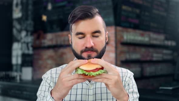 Portrait of Hungry Stylish Man Biting Fresh Appetizing Burger Looking ...