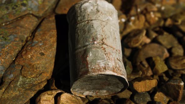 Rusty Destroyed Metal Barrel on Beach Rocks, Motion Graphics | VideoHive