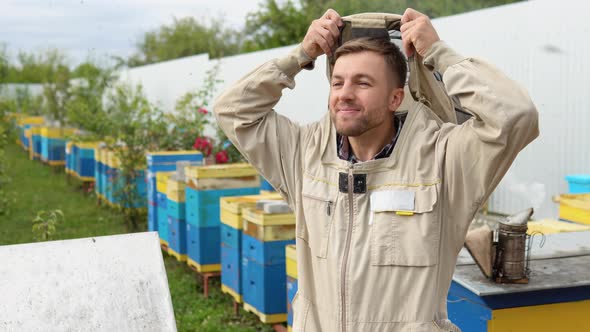 Beekeeper Puts on Protective Suit, Stock Footage | VideoHive