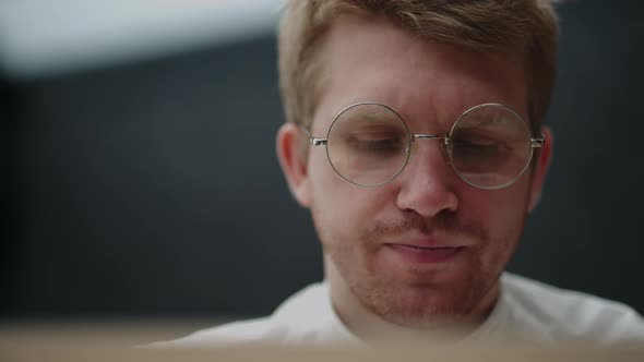 Smart Man with Glasses is Looking at Screen of Notebook and Reading ...