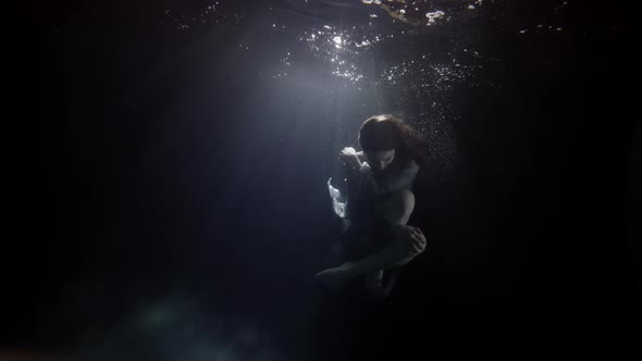 Fragile and Graceful Woman Is Floating in Dark Water of Swimming Pool ...