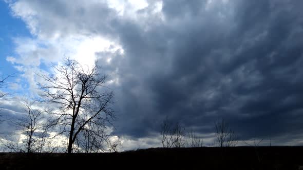 Beautiful clouds in the blue sky. Spring storm clouds with sun rays ...