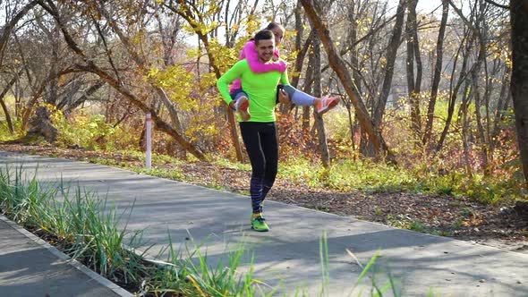 Happy Girl Jumping on Back of her Boyfriend while Jogging in Autumn ...