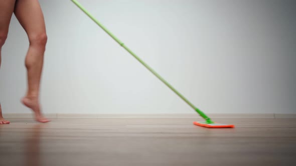 Unrecognizable Woman with Slender Legs Washes Floor Using a Mop, Stock ...