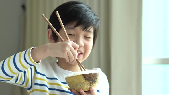Cute Asian Boy Eating Rice With Chopsticks, Stock Footage | VideoHive