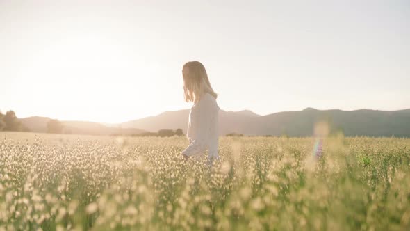 Happy woman feeling free in farm field with swaying plants during ...