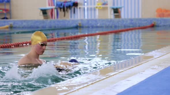 Swimming Instructor Provides Support to a Person Underwater in the Pool ...