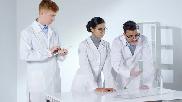 Three Scientists Working in Hi-tech Lab, Stock Footage | VideoHive