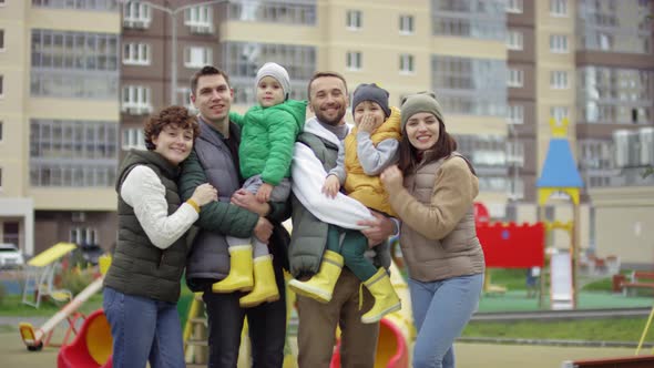 Happy Neighbor Families Posing Together in Playground of Residential ...