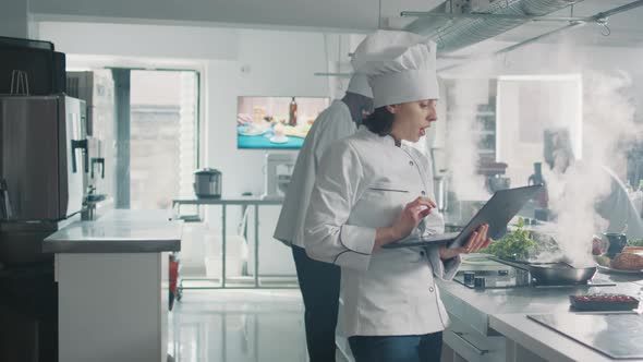 Female Cook Studying Professional Food Recipe on Laptop, Stock Footage