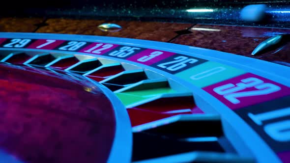 Rotating Roulette Wheel Close Up in the Rays of Blinking Neon Lights ...
