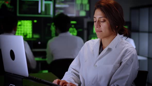 Medical Research Scientist Typing on His Desktop Computer in a ...