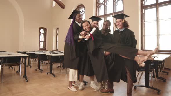 Graduate Students Lifting Up Classmate, Stock Footage | VideoHive