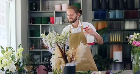 Professional Florist Worker Watering and Spraying Flowers., Stock Footage