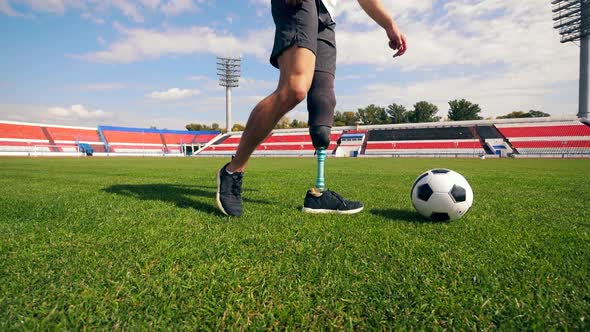 Handicapped Player Is Dribbling a Football in Slow Motion, Stock Footage