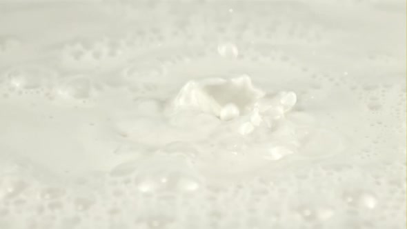 Super Slow Motion Drops of Milk Fall Down with Splashes, Stock Footage