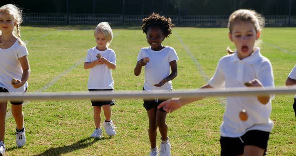 Children playing lemon and spoon race, Stock Footage | VideoHive