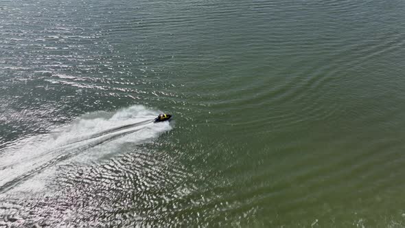 An aerial view over Gravesend Bay in Brooklyn, NY as a jet ski rider ...