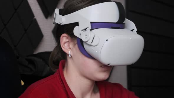 Young Woman in VR Helmet Sitting on Sofa and Communicating in Virtual ...
