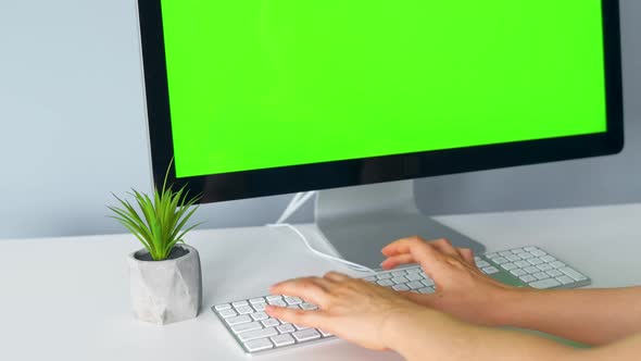 Woman Typing on a Computer Keyboard, Monitor with a Green Screen ...
