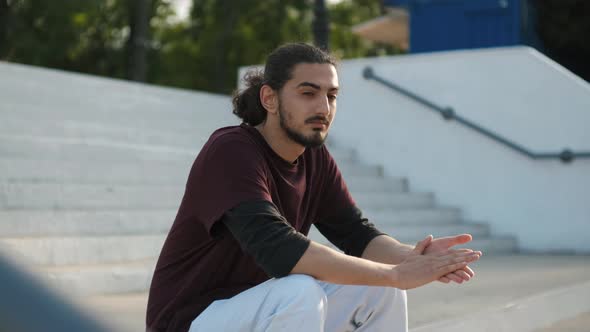 Portrait of Young Attractive Arab Man Sitting on the Stairs in Park at ...