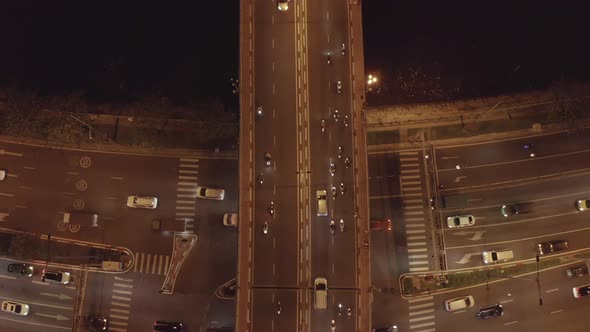 top down view of busy traffic bridge and underpass at night with ...