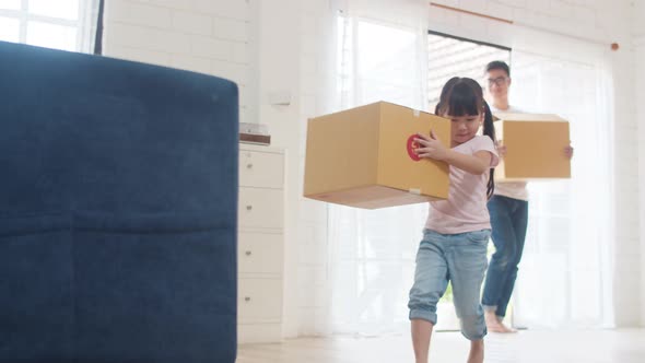 Mom, Dad, and child smile happy hold cardboard boxes for move object ...