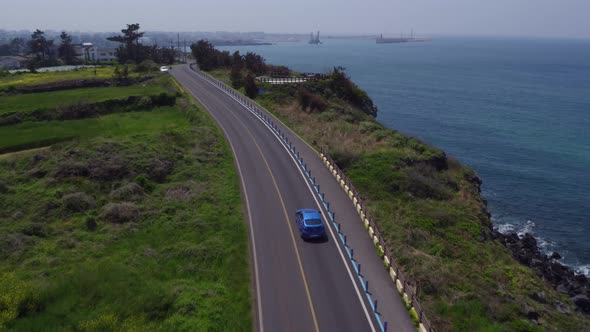 Blue Car Driving along Coastal Road, Stock Footage | VideoHive