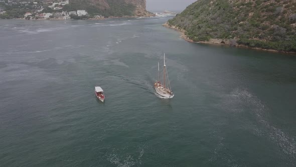 Aerial: Sailing ship and tour boat in Knysna Harbour lagoon, Stock Footage