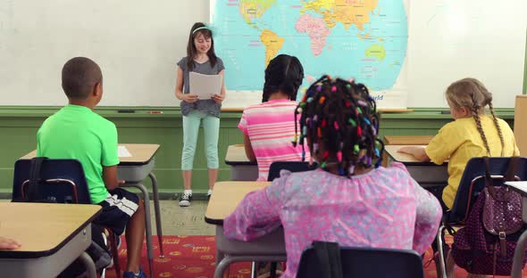 Student reading paper in front of class, Stock Footage | VideoHive