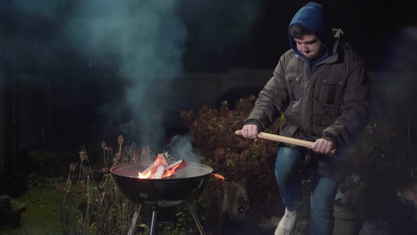 Guy Trying to Break a Stick on His Knee, Stock Footage | VideoHive