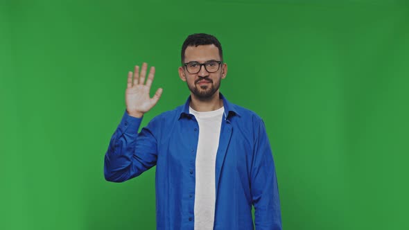 Man Waves His Hand at the Camera While Standing on the Background of a ...
