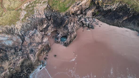 AERIAL: Wide circle shot of large blue rockpool with seabirds, Blue ...
