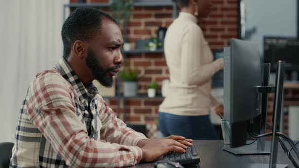 Portrait Of Programer Typing Programming Code On Computer Keyboard Turning Head And Smiling