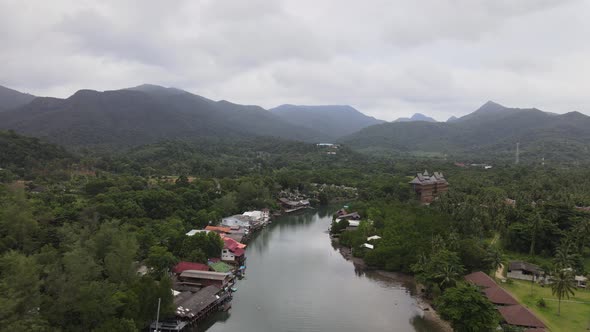 Aerial view of river and mountainous scenery, backwards reveal shot ...