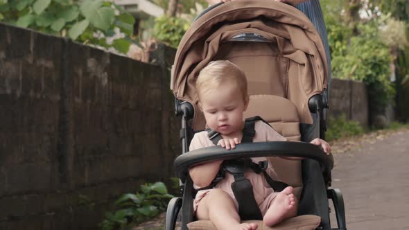Caucasian Toddler in Moving Stroller Outdoors, Stock Footage | VideoHive