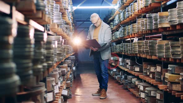 Male Archivist is Keeping the Record of Vintage Film Tapes, Stock Footage