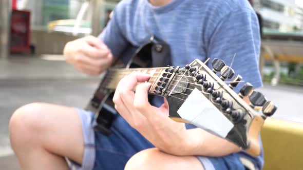 Street Musician Strumming Guitar on the Street Outdoors While Passerby ...