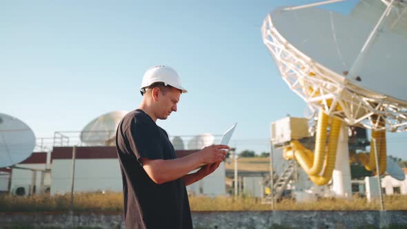 Engineer Looking Earth Based Astronomical Radio Telescope, Stock Footage