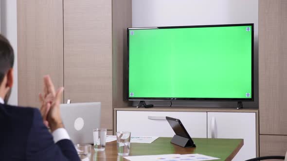 Businessman in Conference Room Talking with a Green Screen TV, Stock ...