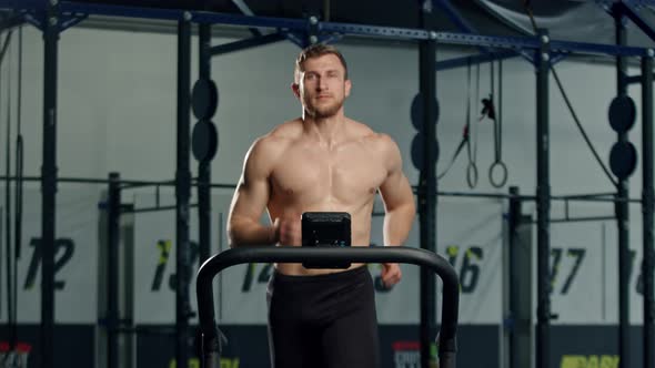 Male athlete athlete is doing cardio training on a treadmill ...