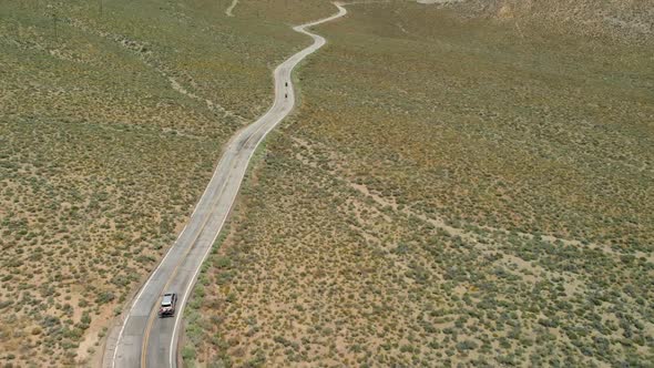 Slow Motion Aerial of Motorcycles and Car on Scrubby Hill, Stock Footage