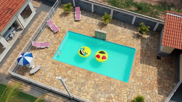 Smile emoji icon floating at swimming pool at countryside, Stock Footage