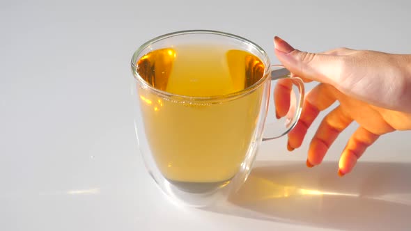 Woman Hand Take Cup of Tea From White Table Herbal Tea in Transparent ...