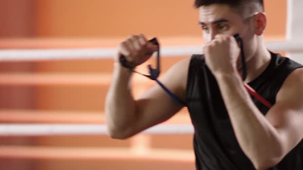 Male Fighter Practicing Punches with Resistance Band, Stock Footage