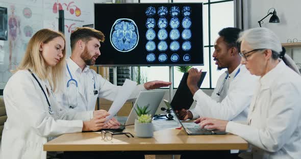 Team of Neurologists Working Together in Modern Medical Room with ...