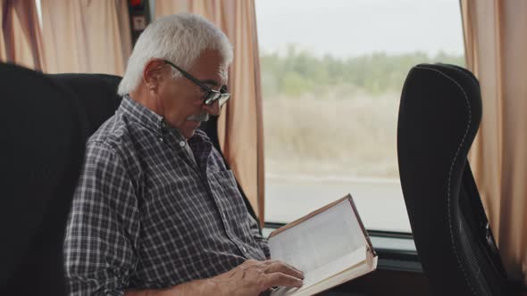 Senior Man Reading Book during Bus Ride, Stock Footage | VideoHive